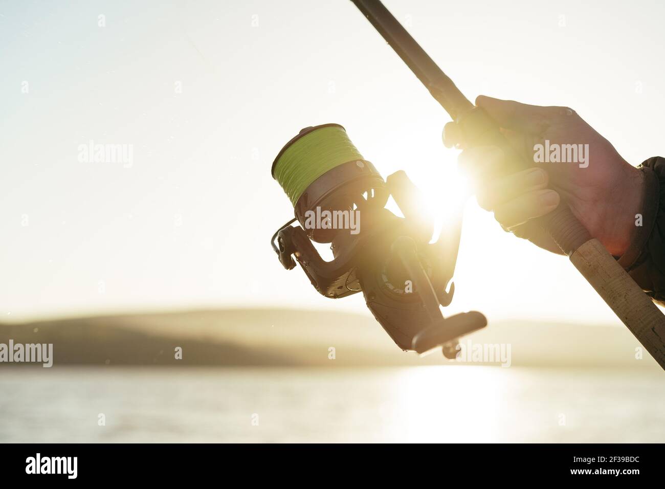 Fisherman hands holding fishing rod close up Stock Photo - Alamy