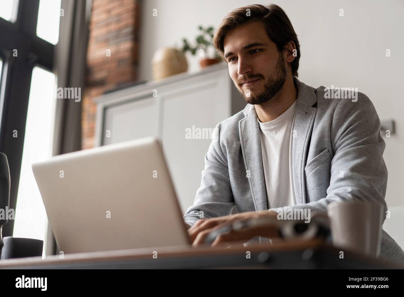 Male remote working from home and having work confrence video call ...
