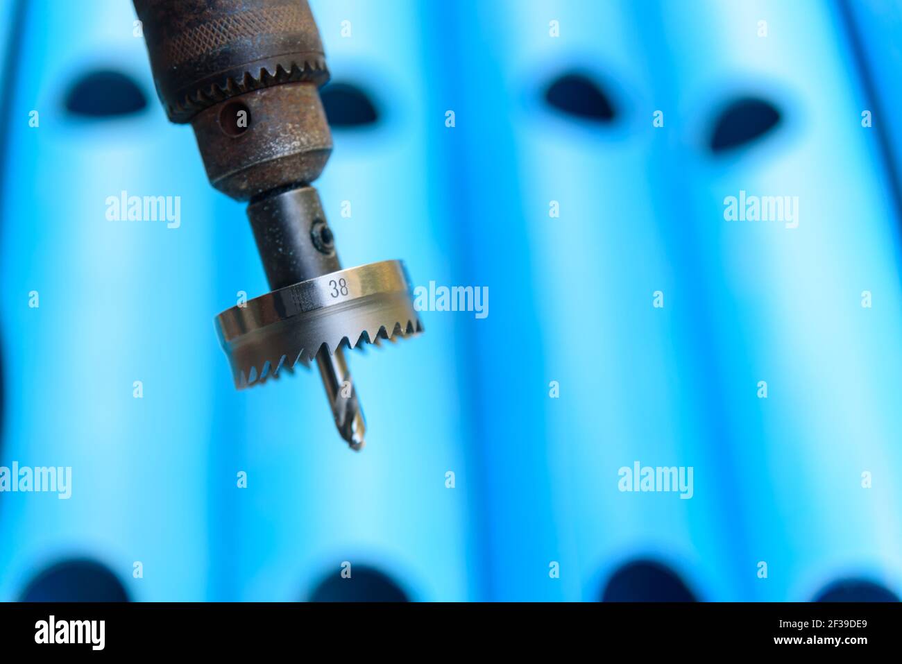 The man use HOLE SAW Perforate the PVC pipe hole Stock Photo - Alamy