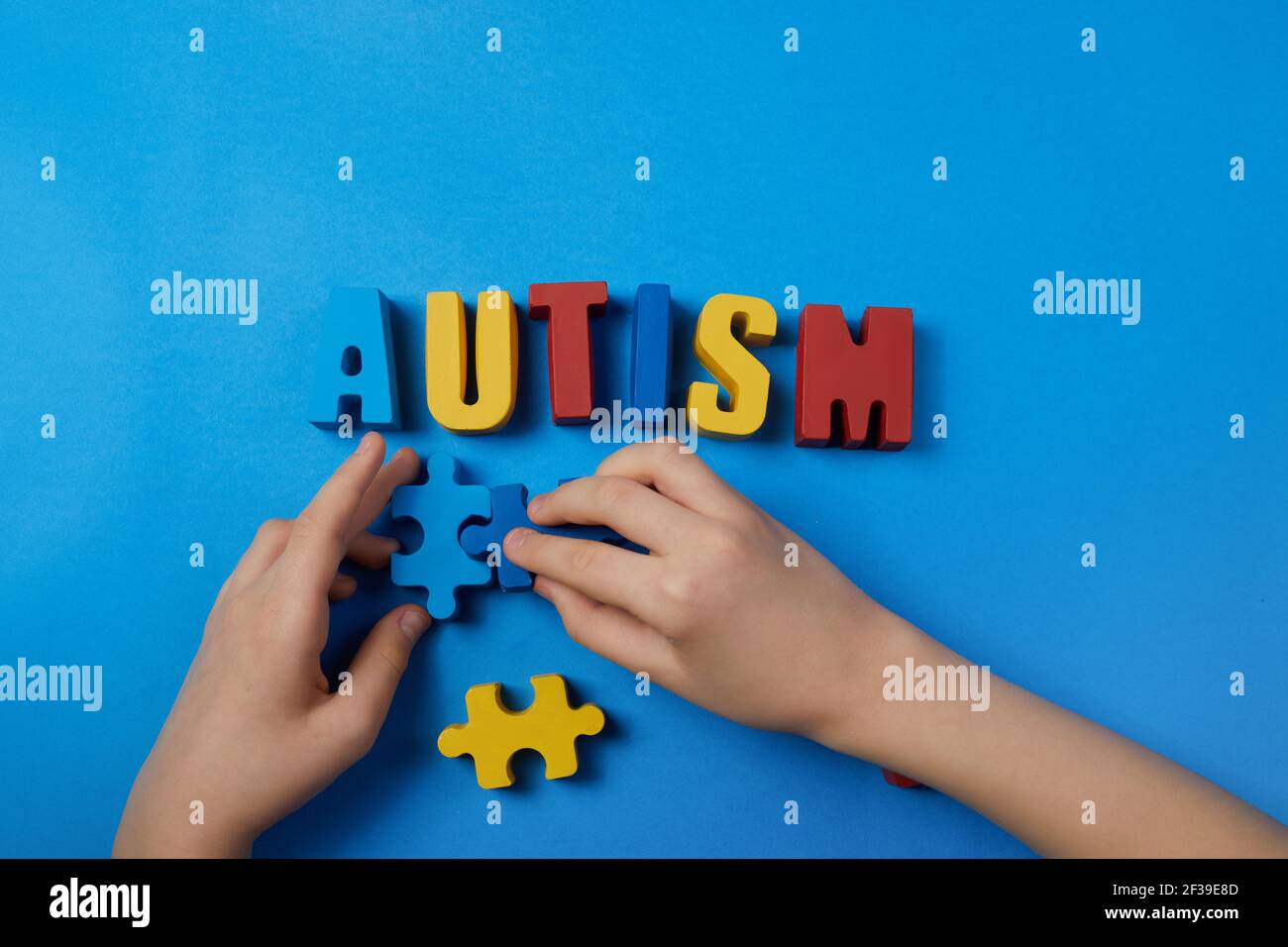 Autistic kid hands holding puzzle jigsaw and word autism, mental health ...