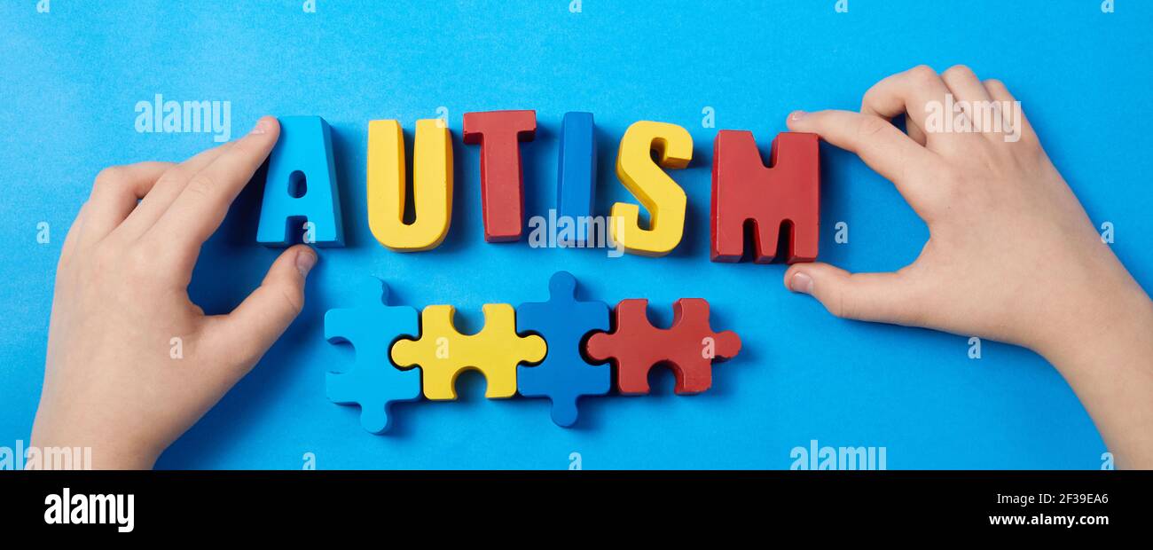Autistic kid hands holding puzzle jigsaw and word autism, mental health ...