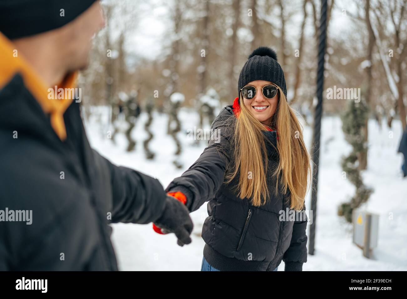 Young happy couple in love having a walk in a winter park Stock Photo ...