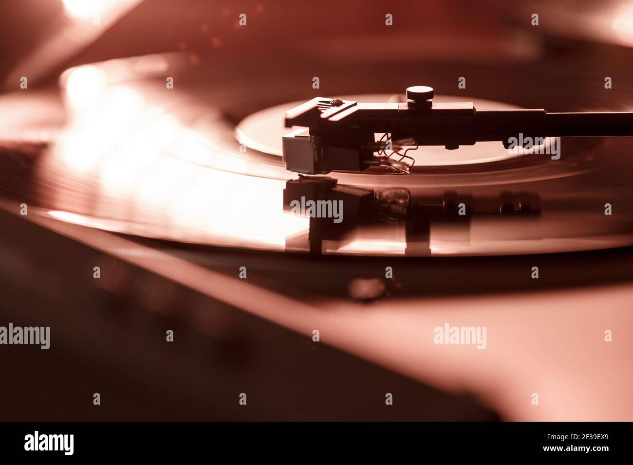 Closeup view of a tonearm and turntable playing vinyl record ...