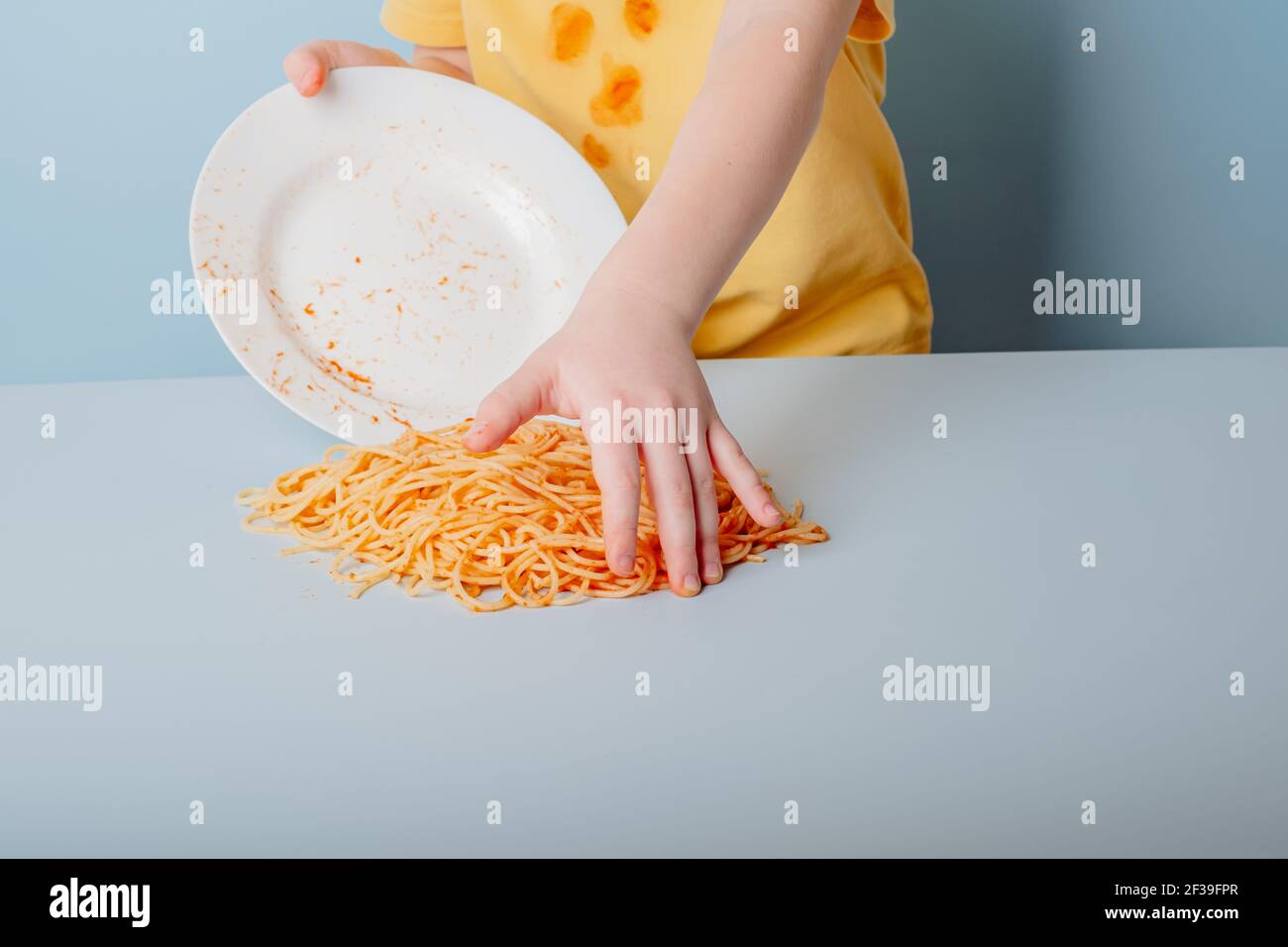 Child eating spaghetti with hands hi-res stock photography and images ...