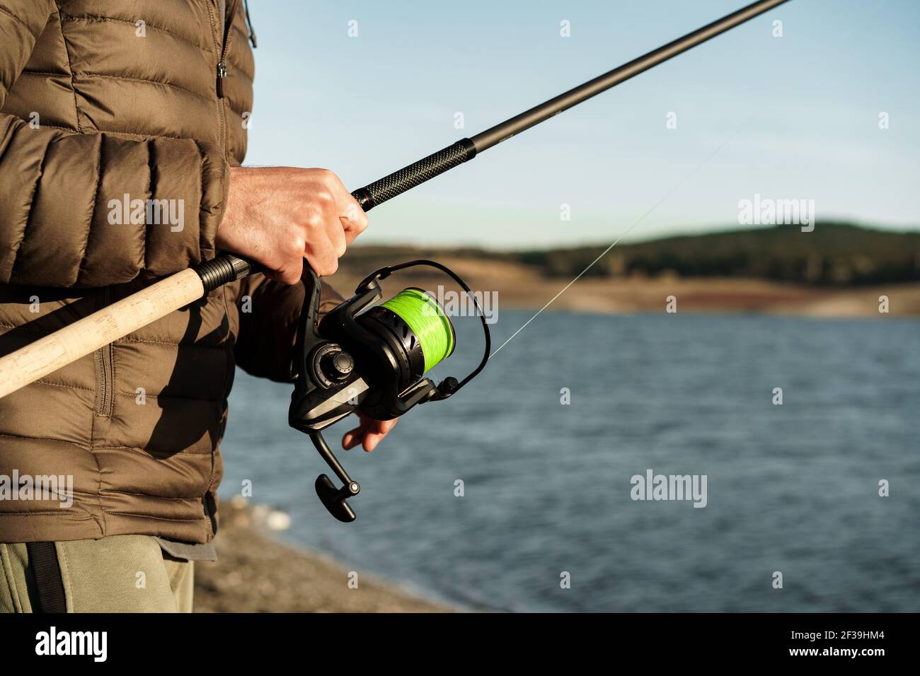 Fisherman hands holding fishing rod close up Stock Photo - Alamy