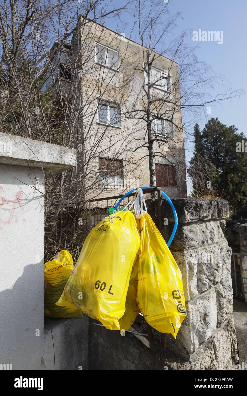 Yellow plastic recycling bags hung at the entrance to the house. Zagreb ...