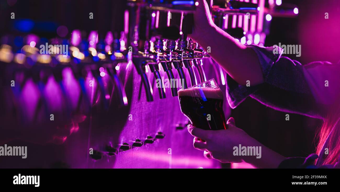 Close-up beer pumps taps in pub or bar in multicolored neon light Stock ...