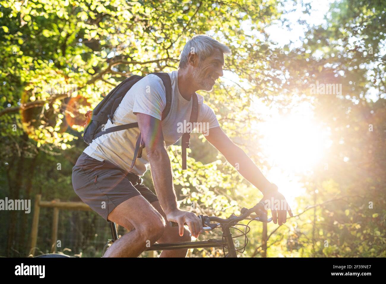 Man looking back cycling hi-res stock photography and images - Alamy