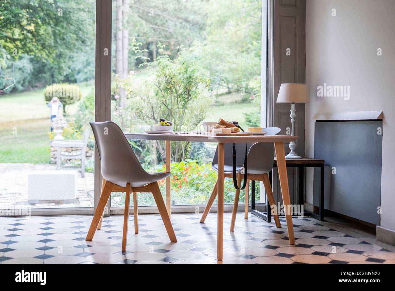 Interior view of breakfast on table by window at home Stock Photo - Alamy