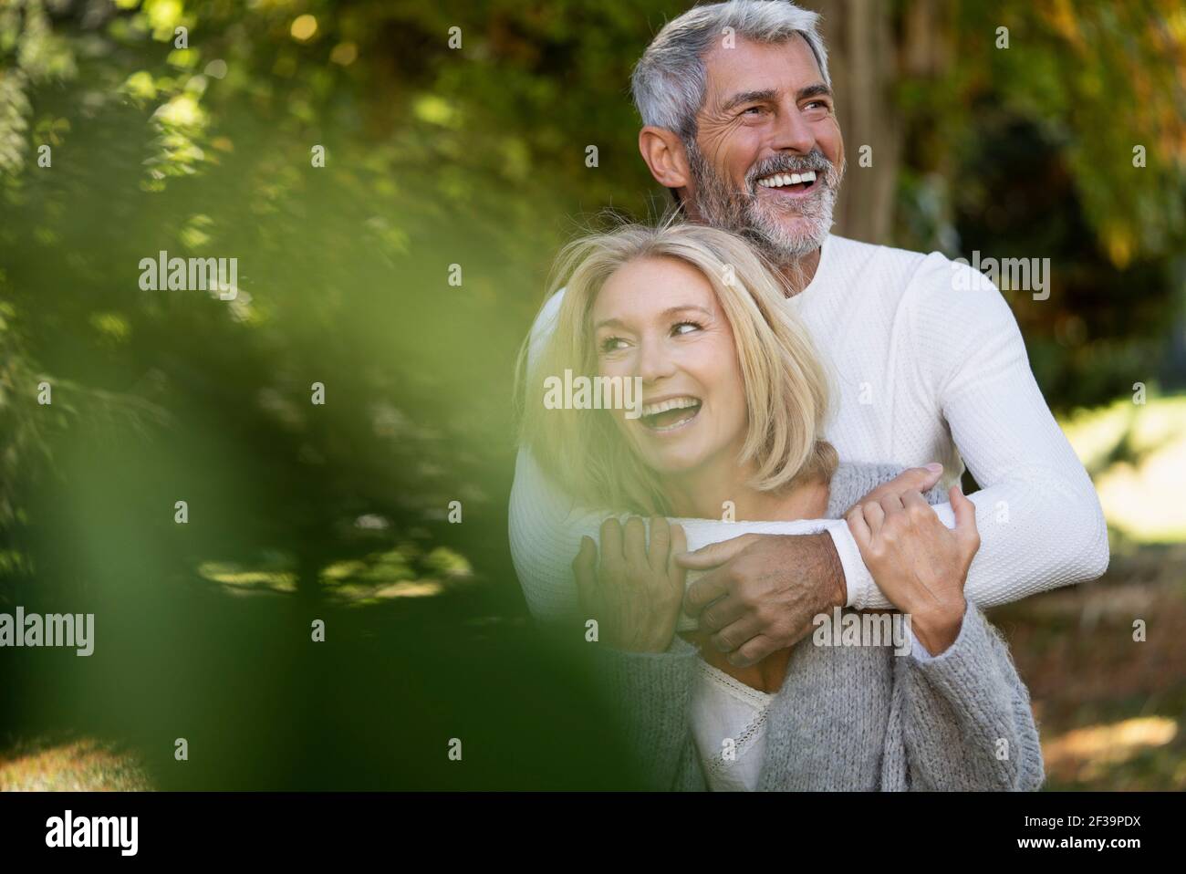Happy mature couple embracing each other in backyard Stock Photo - Alamy
