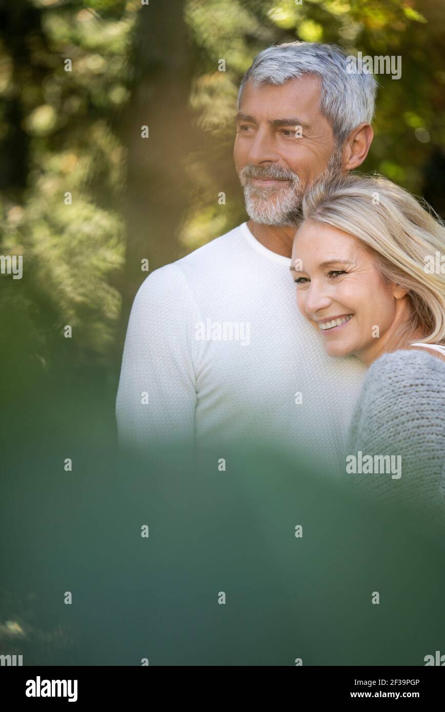 Smiling mature couple embracing each other in backyard Stock Photo - Alamy