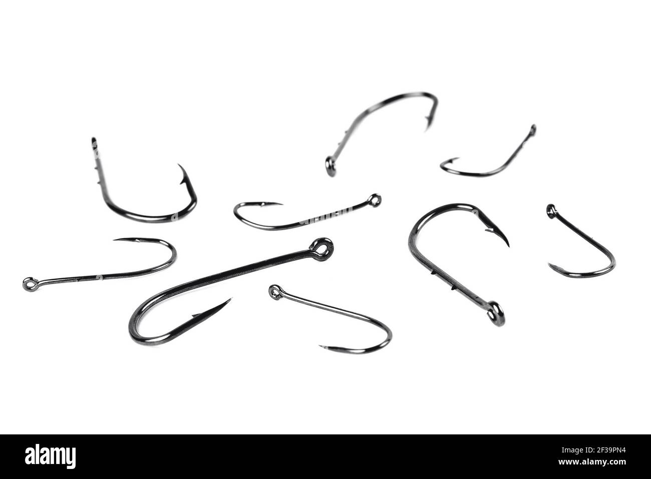 fish hooks of different sizes on a white background, close-up Stock ...