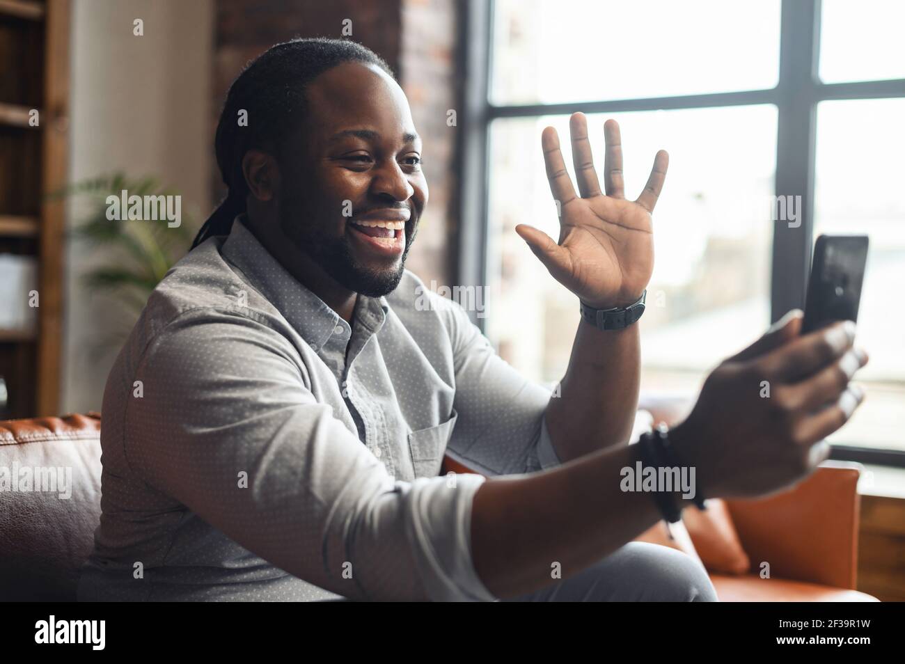 Joyful man greeting friends colleagues hi-res stock photography and ...