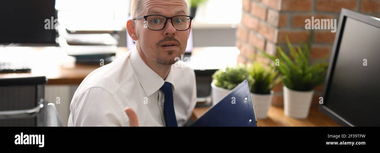 Professional manager sit in office at workplace, hold folder with ...