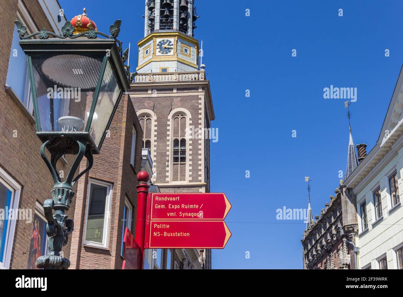 Tourist sign in front of the historic tower of Kampen, Netherlands ...