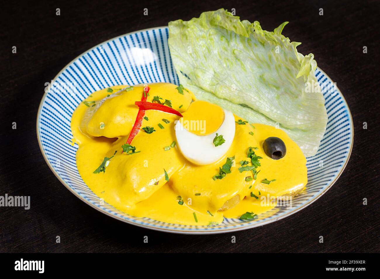 Peruvian traditional food. Potatoes with aji, yellow sauce, boiled eggs ...