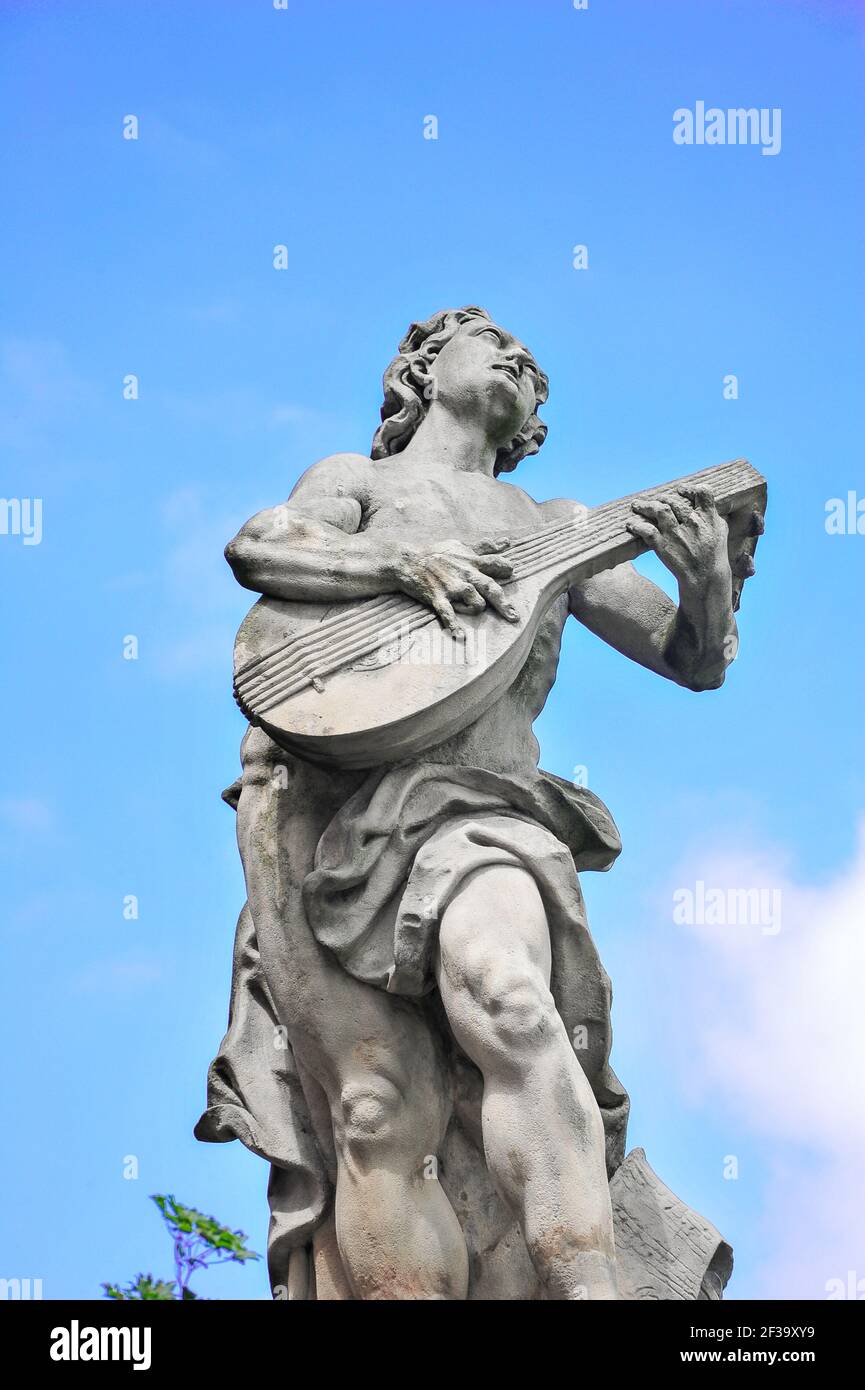 Statue of a musician playing a lute in the gardens of Książ Castle ...