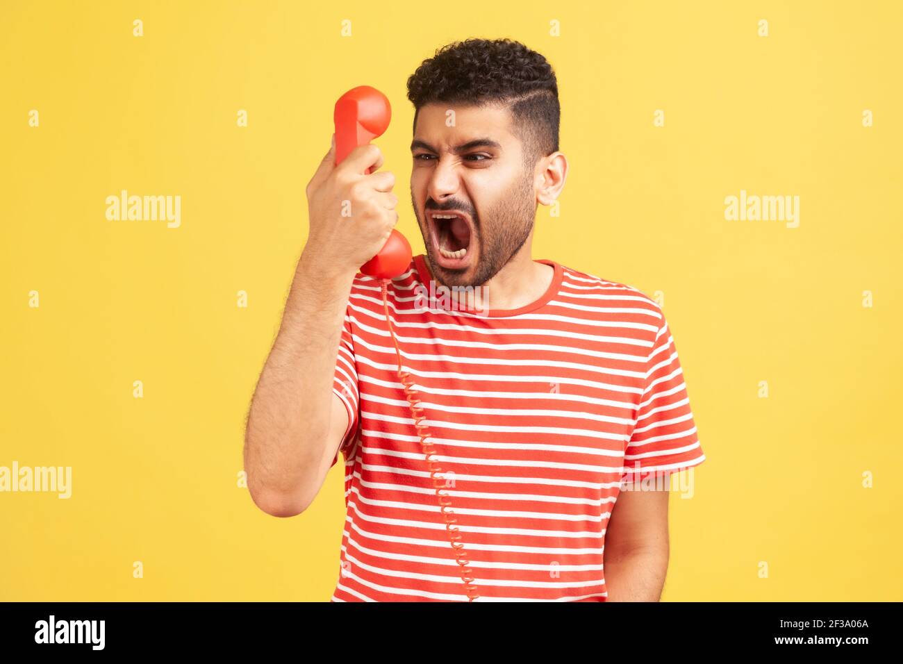 Angry nervous bearded man in striped t-shirt screaming and yelling ...