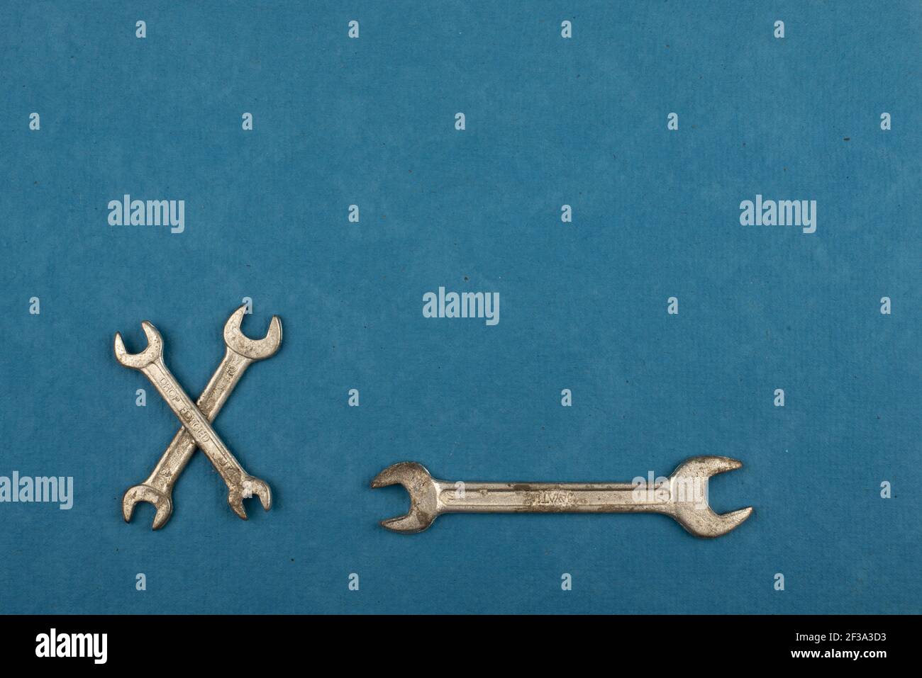 A set of wrenches on a blue background Stock Photo - Alamy
