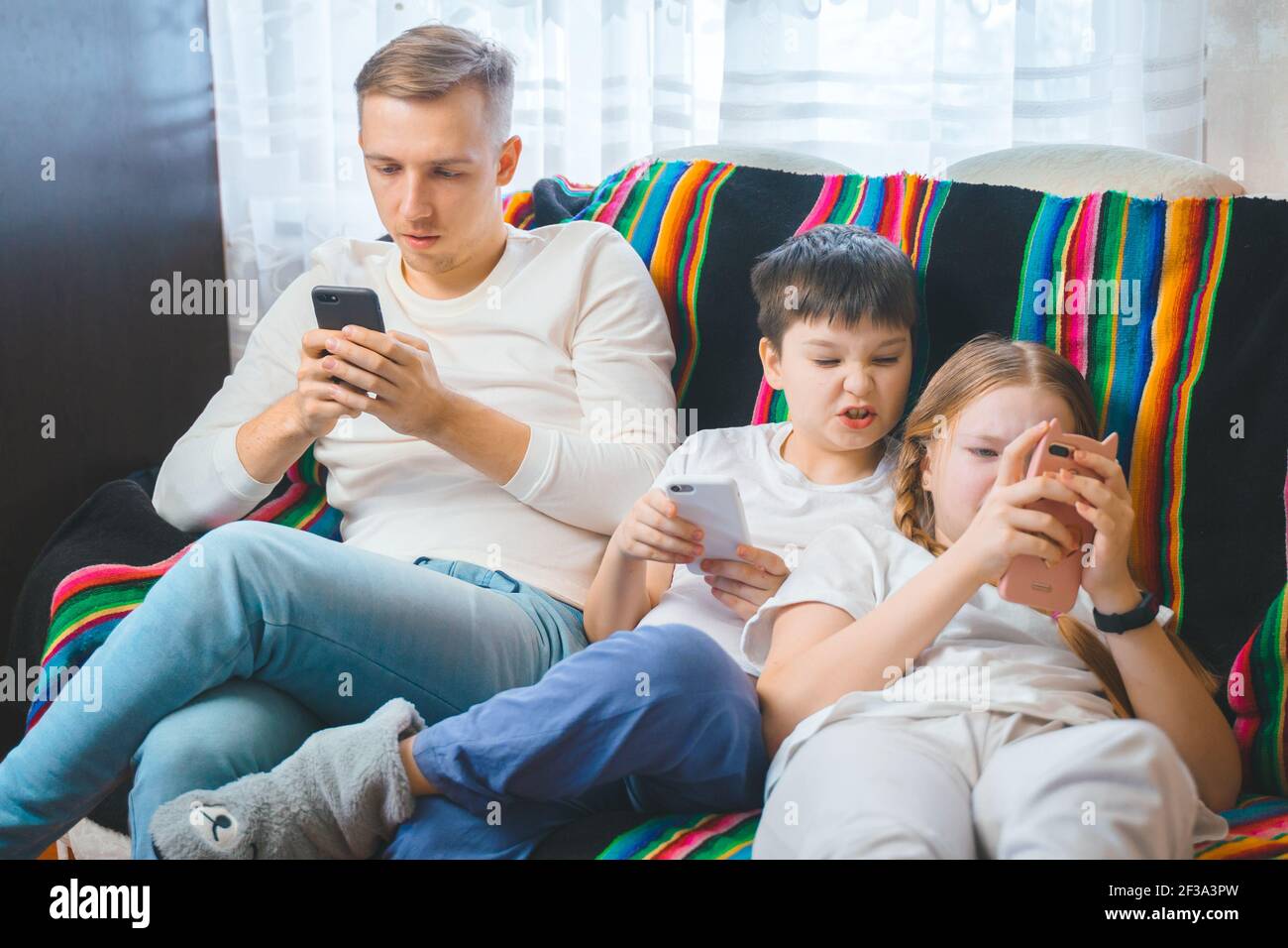 Cheerful young family dad son teen daughter children watching online ...