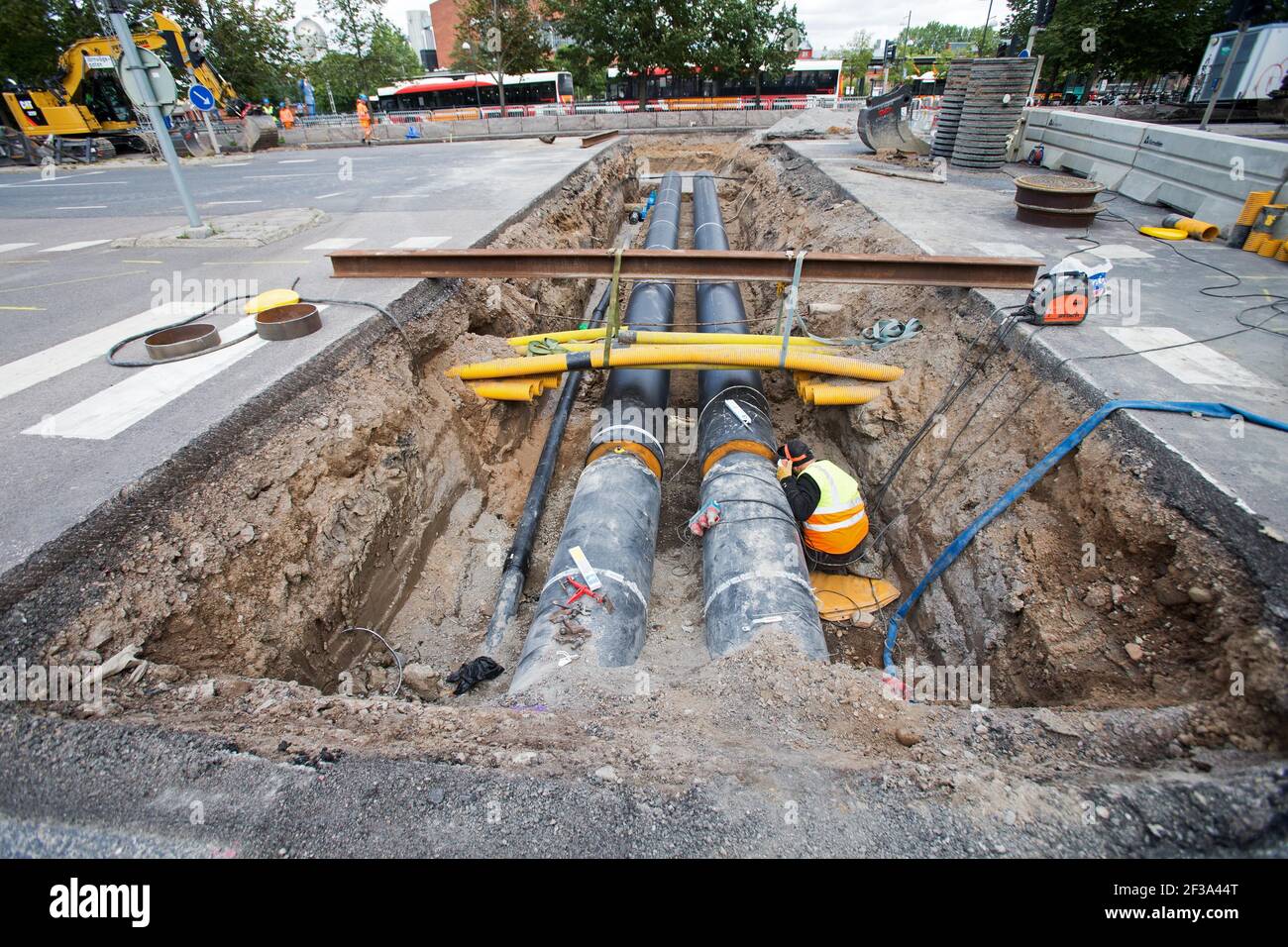 Replacing district heating pipes under a street Stock Photo - Alamy