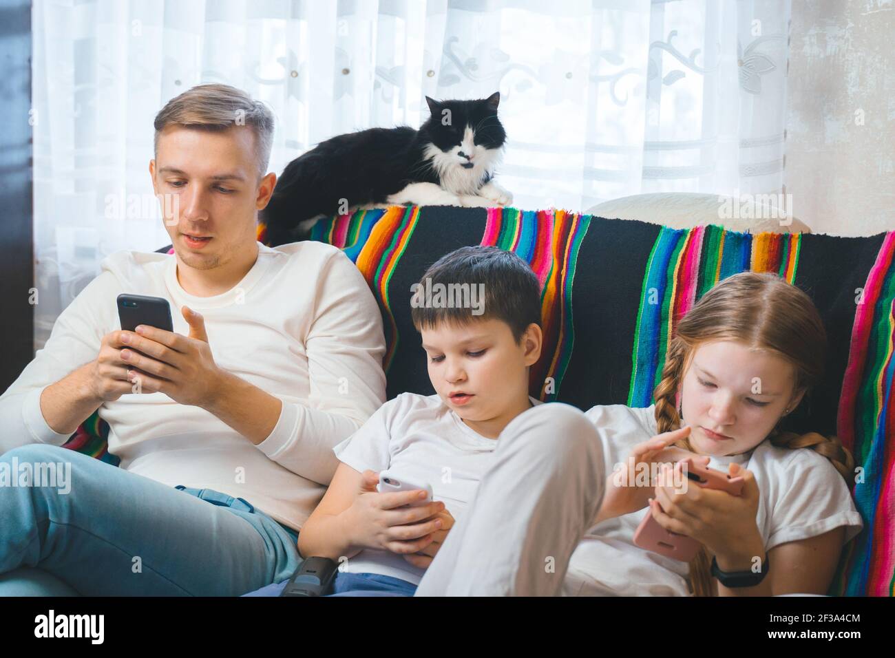 Happy alone dad looking at phone screen with children kids. smiling ...