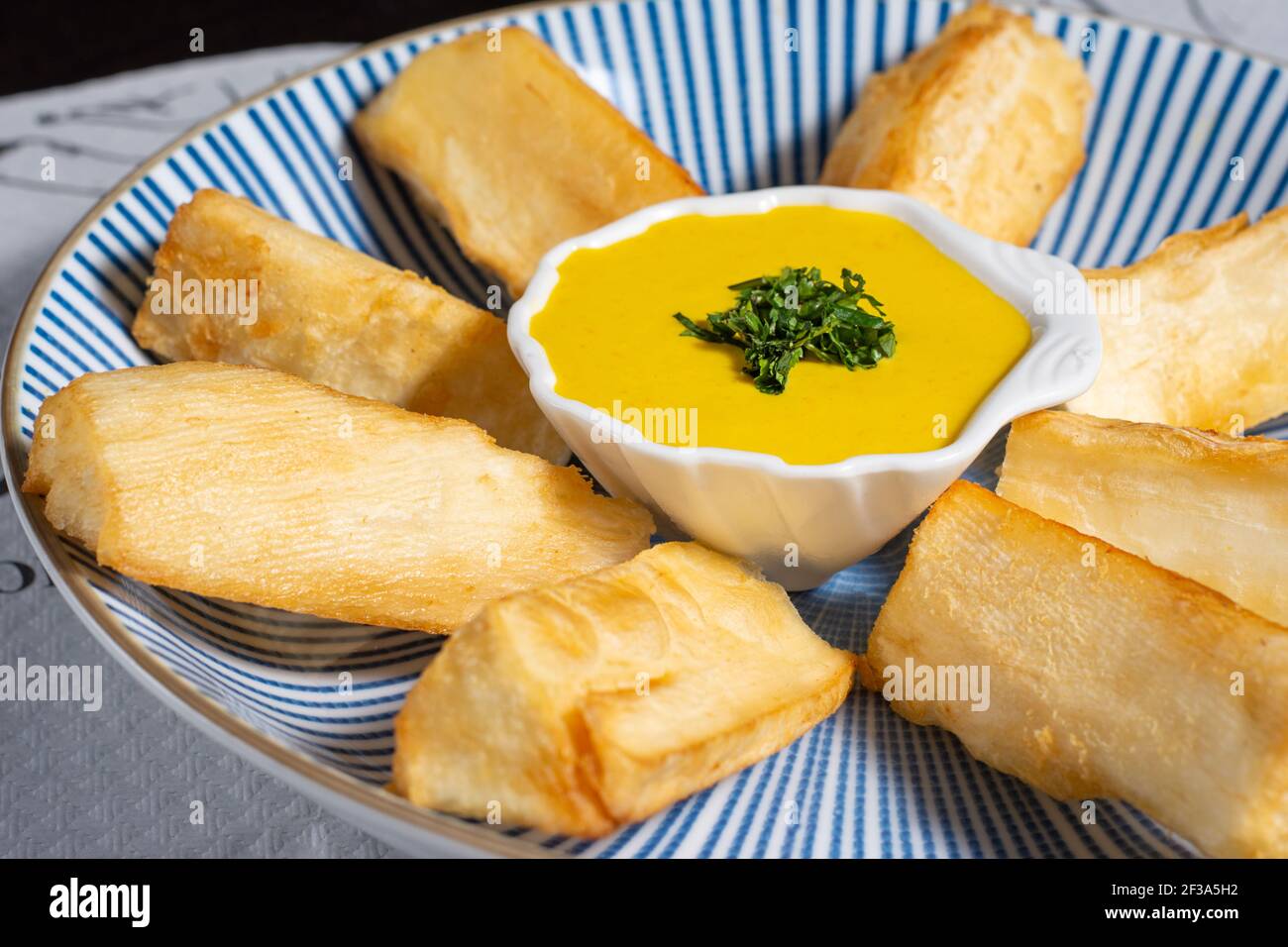 Peruvian traditional food. Fried yucca with sauce Stock Photo - Alamy