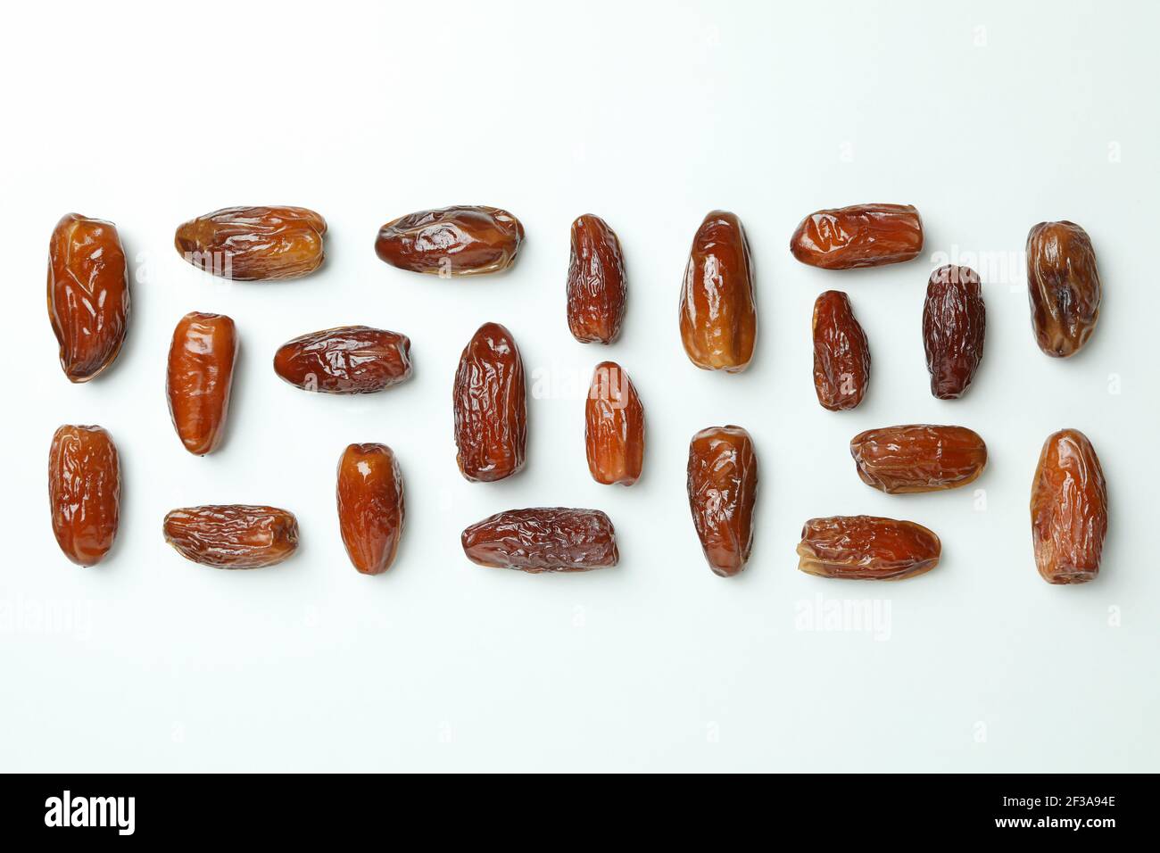 Flat lay with tasty dates on white background Stock Photo - Alamy