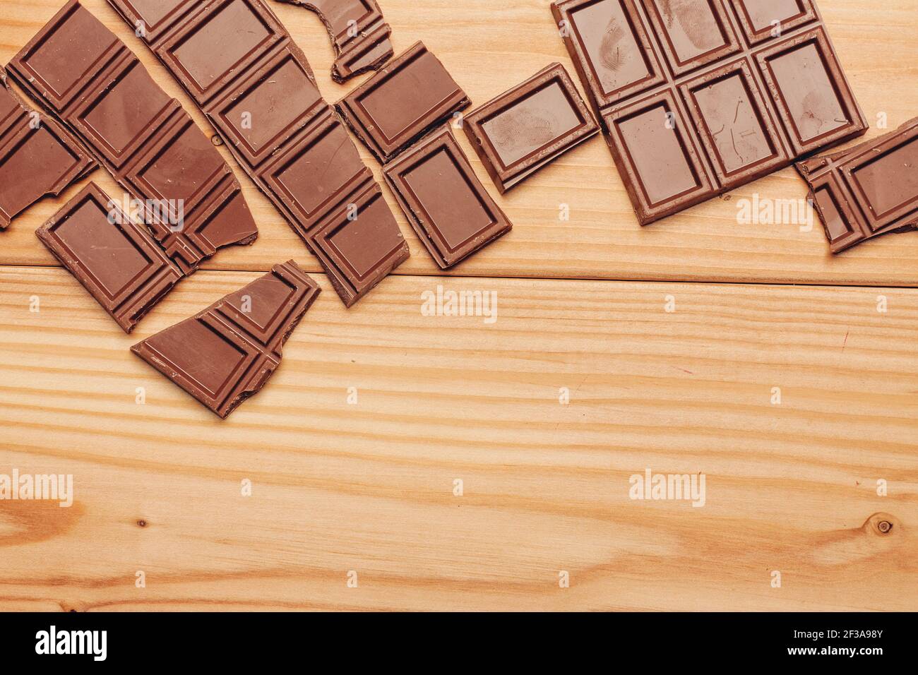 broken bar of chocolate on wooden background texture sweets Stock Photo ...