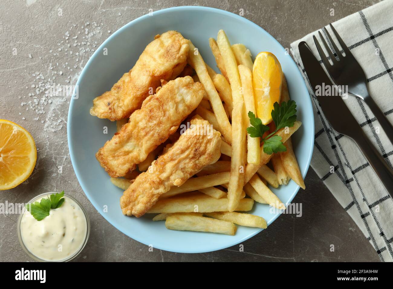 Concept of tasty eating with fried fish and chips on gray textured ...