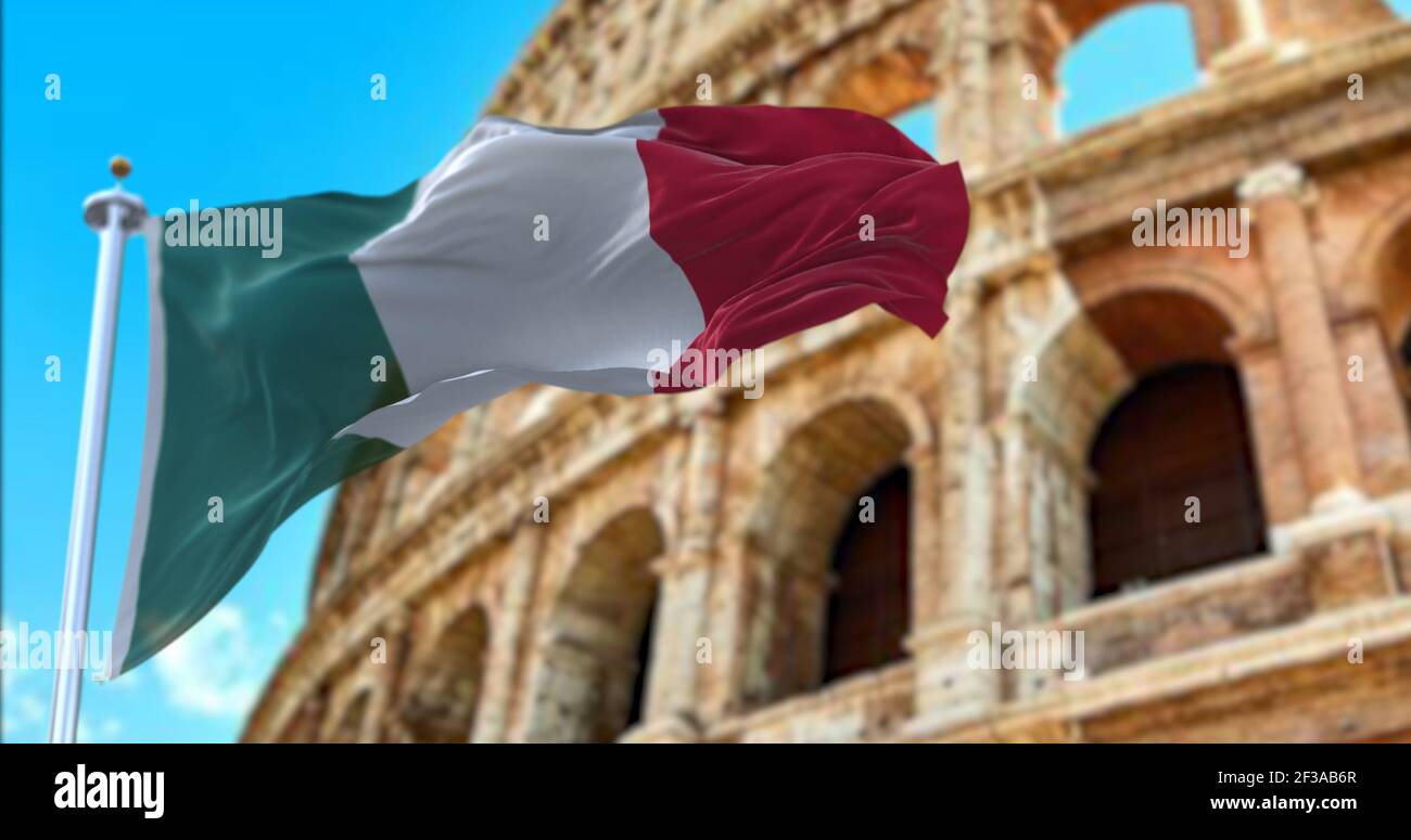 The Italian flag flapping in the wind with the Colosseum blurred in the ...