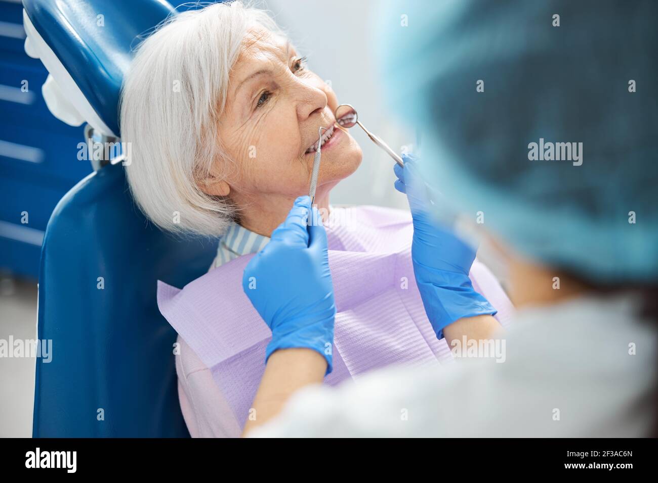 Old person having her teeth checked during dental examination Stock ...