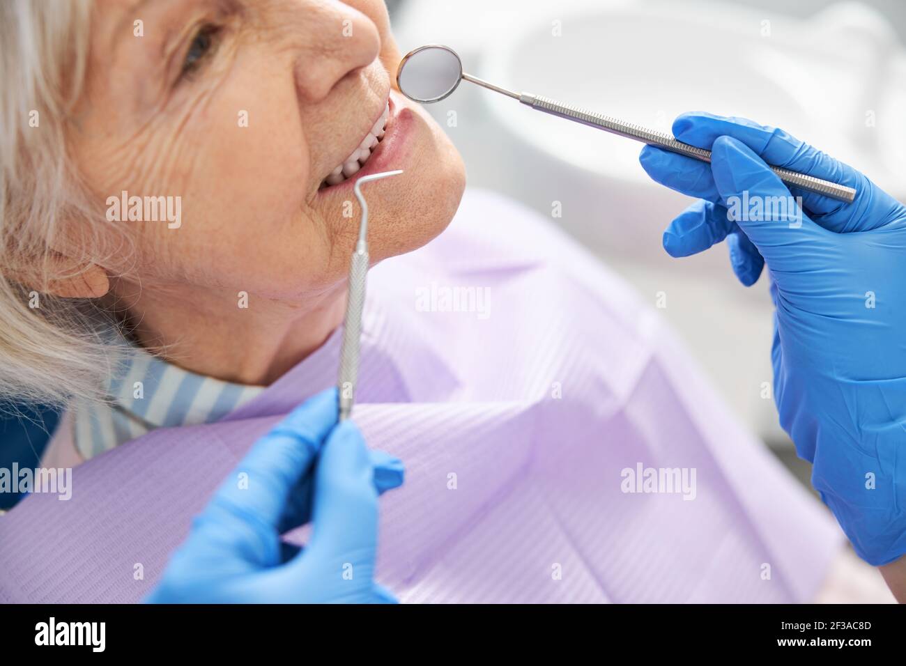 Inspection of teeth performed with dental mirror and probe Stock Photo ...