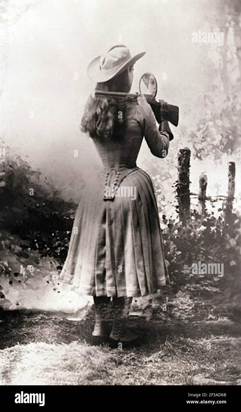Oakley shooting over her shoulder using a hand mirror Stock Photo - Alamy