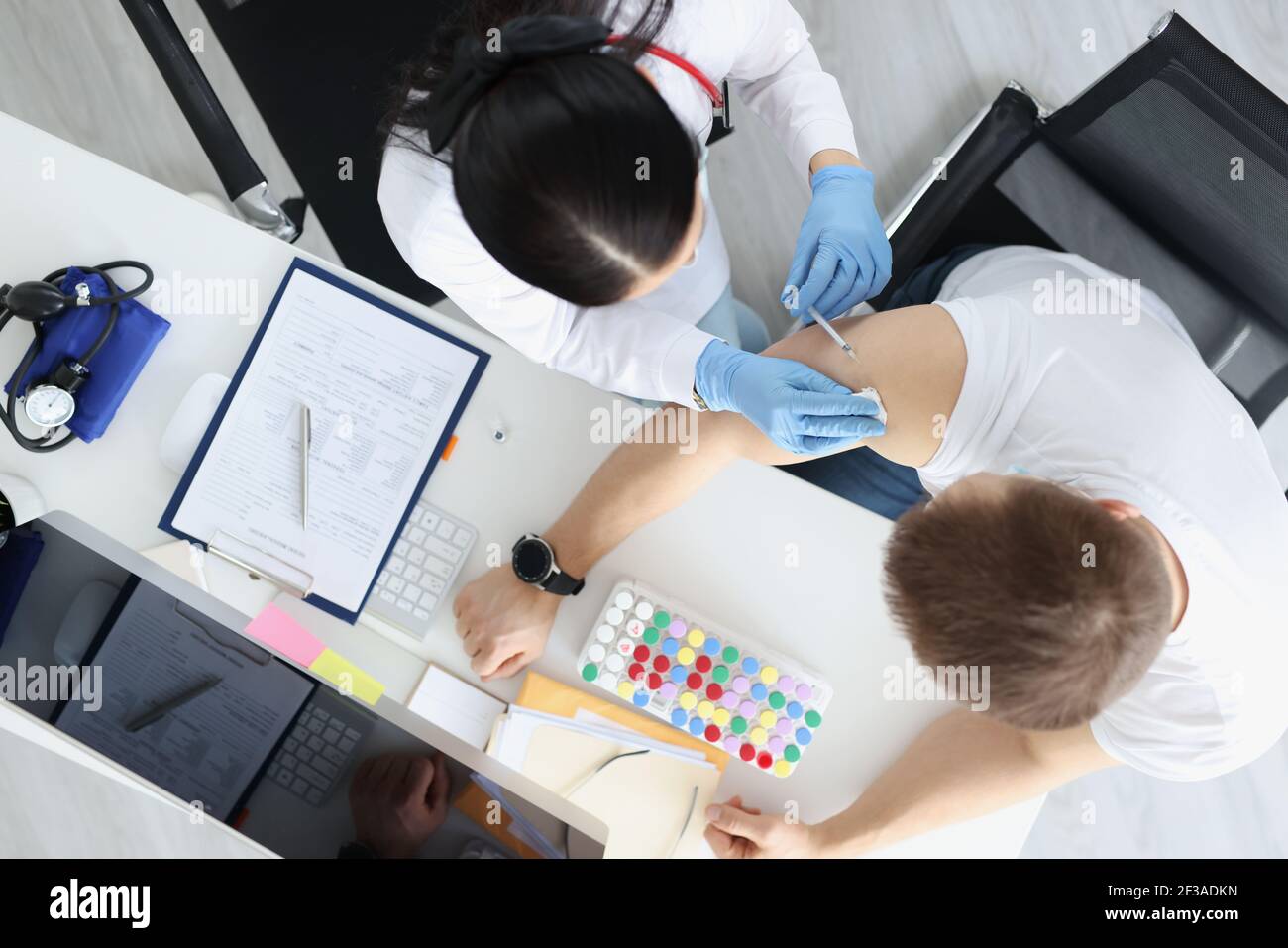 Nurse making injection into patients shoulder top view Stock Photo - Alamy