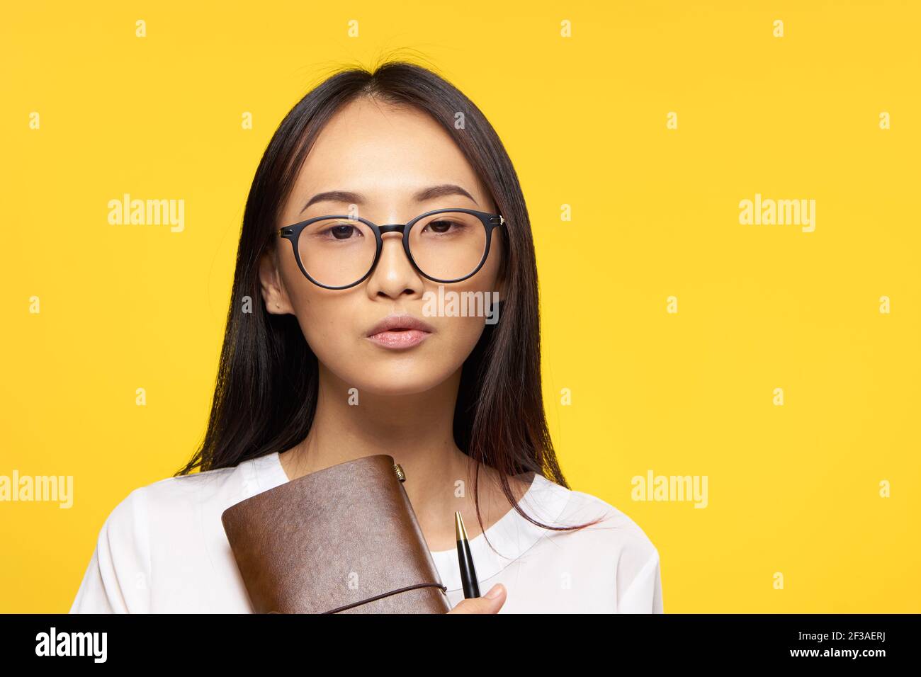 pretty brunette in white shirt holding notepad with pen office yellow ...