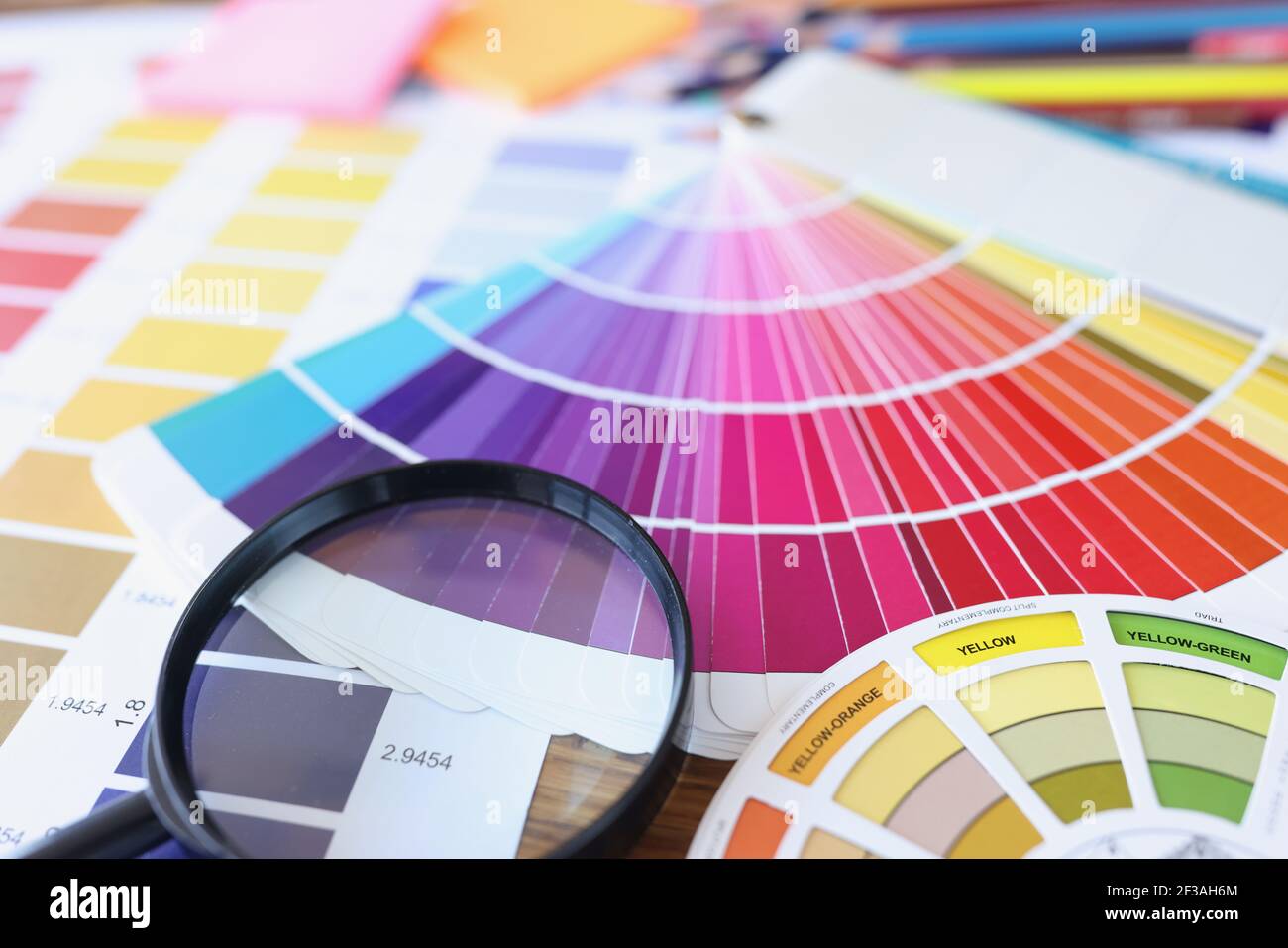 Color swatches and magnifying glass lying on table closeup Stock Photo ...