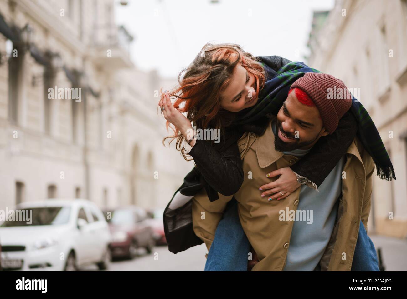 Happy afro american man giving piggyback ride his laughing girlfriend ...