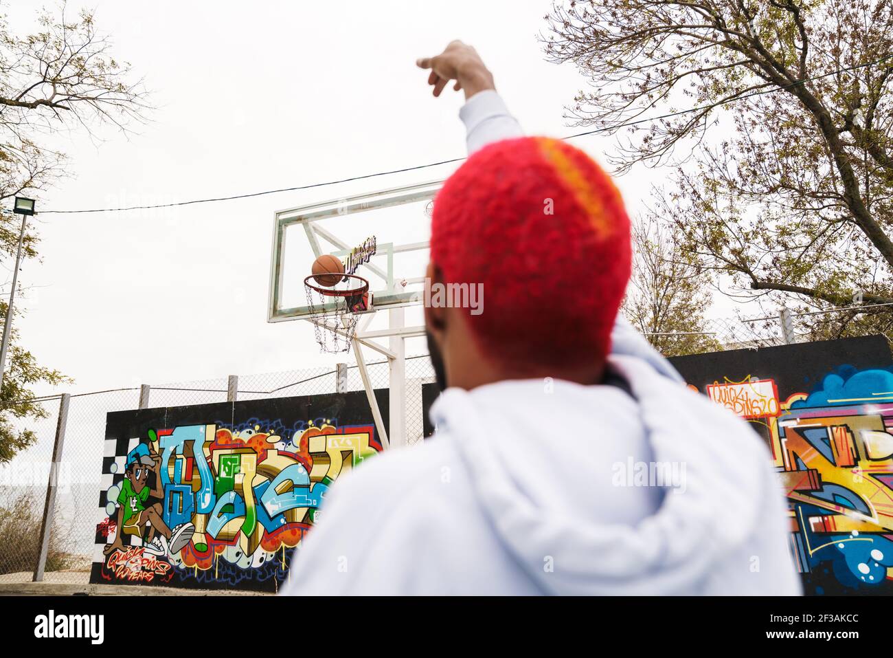 Bearded african american guy playing basketball at playground outdoors ...