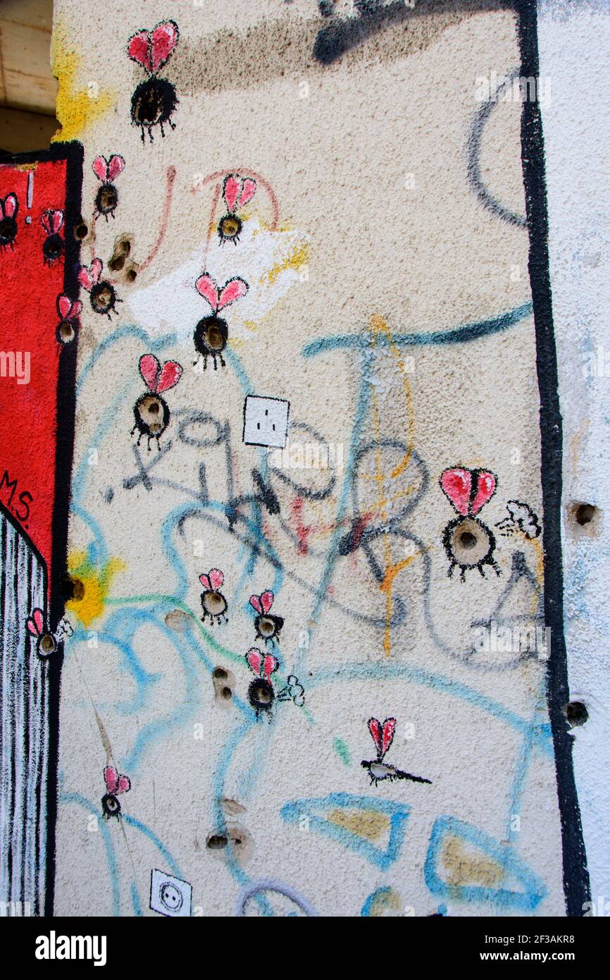 Graffiti around bullet holes in the wall of sniper tower,a former bank ...