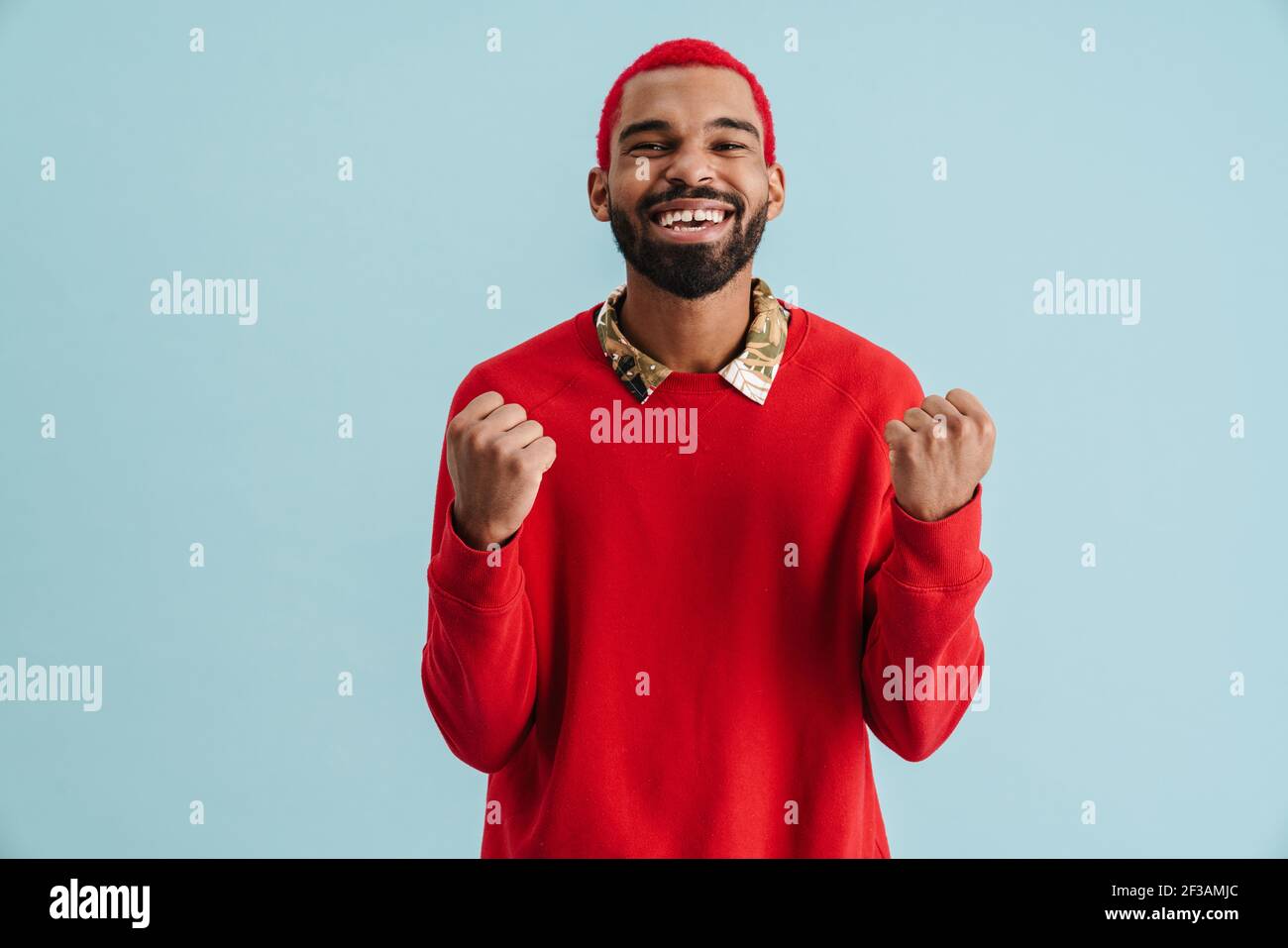 Excited african american guy screaming and showing winner gesture ...