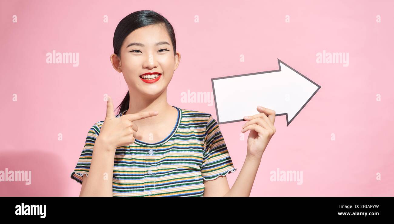 Pretty girl showing direction isolated hi-res stock photography and ...
