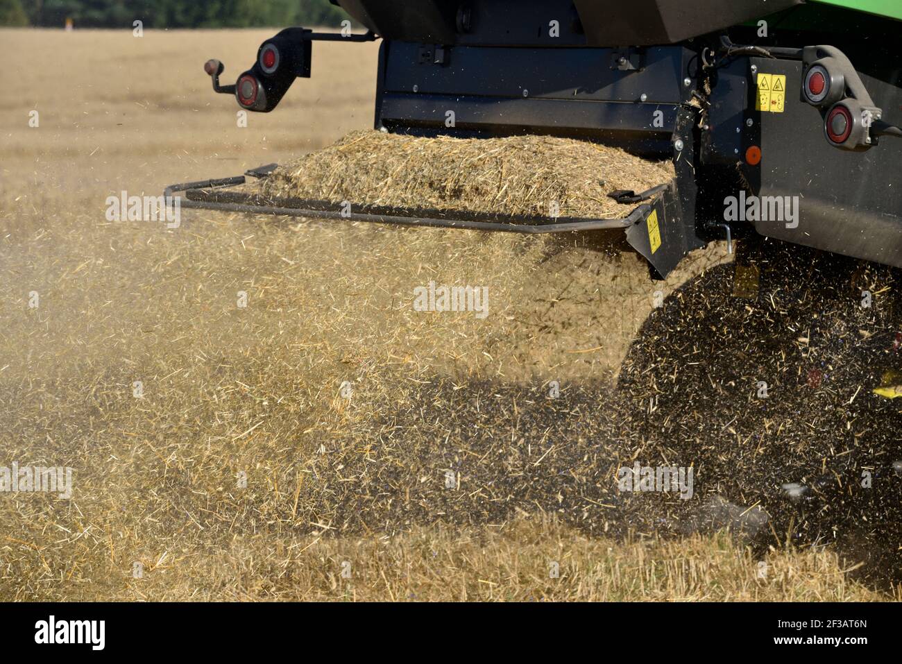 the combine harvester ejects cut straw during operation Stock Photo - Alamy