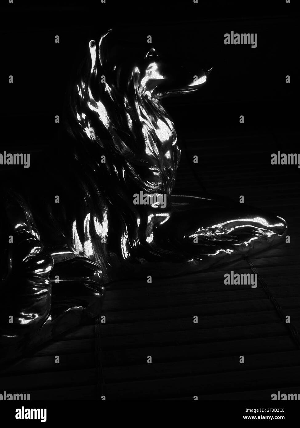 Bronze statue of a wolf howling at the stand side view isolated on ...