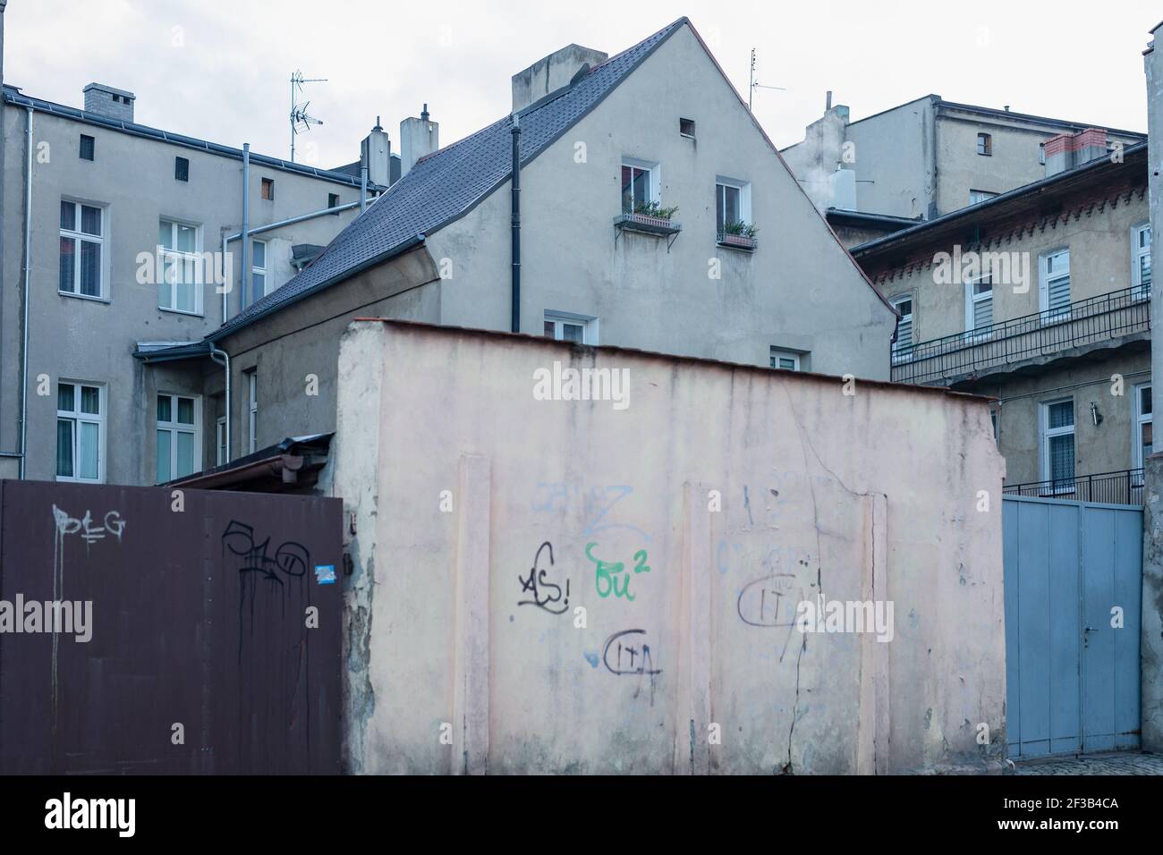 The squalid, seedy buildings of the poor district in Gniezno, Poland ...