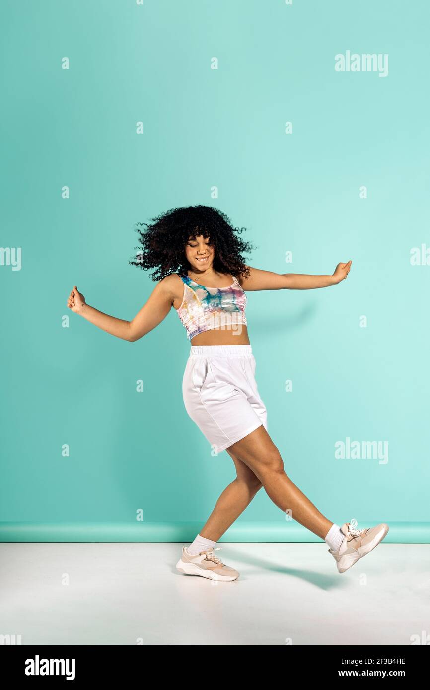 Stock photo of beautiful african woman with curly hair dancing in ...