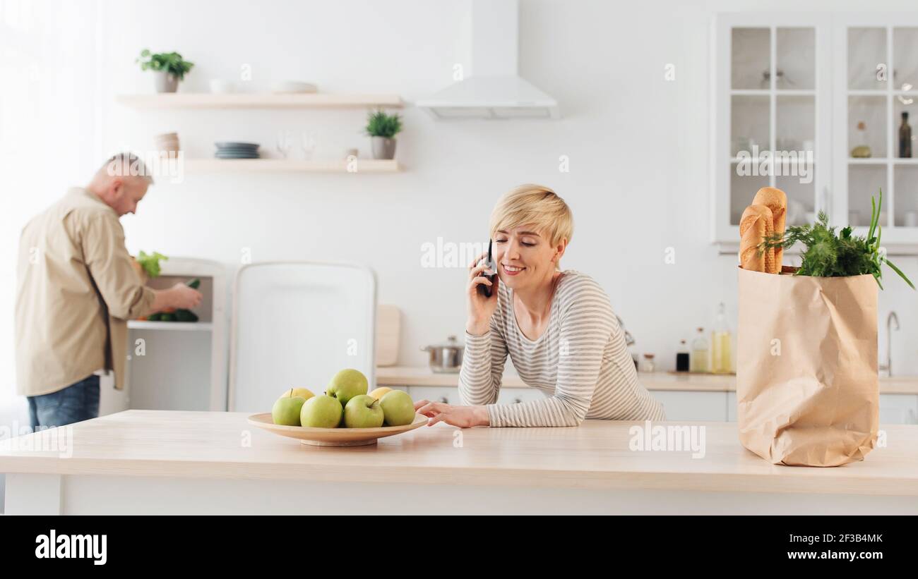 Cooking together in modern kitchen at home, couple after groceries ...