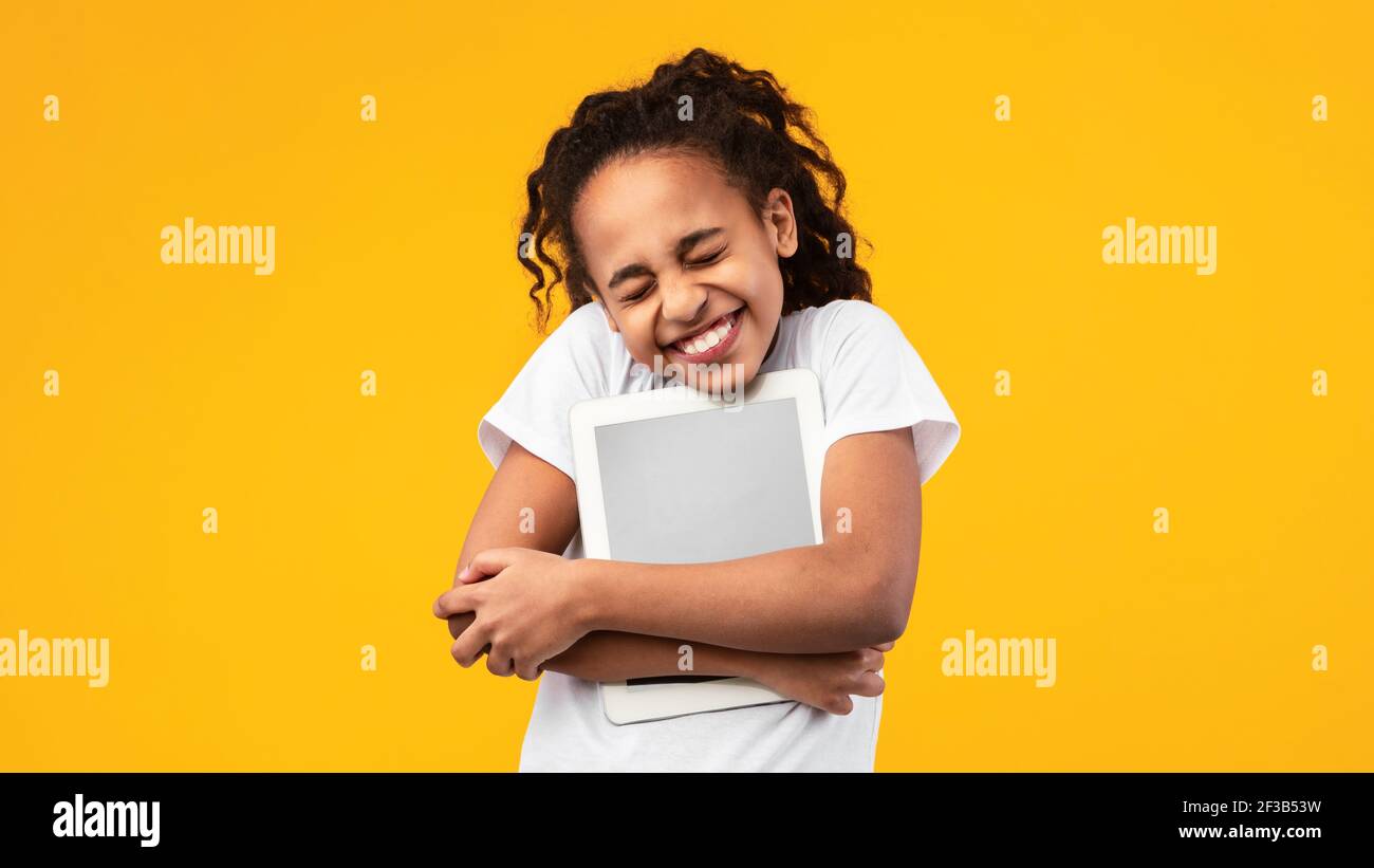 Technology Lover. Excite black girl hugging personal computer Stock ...
