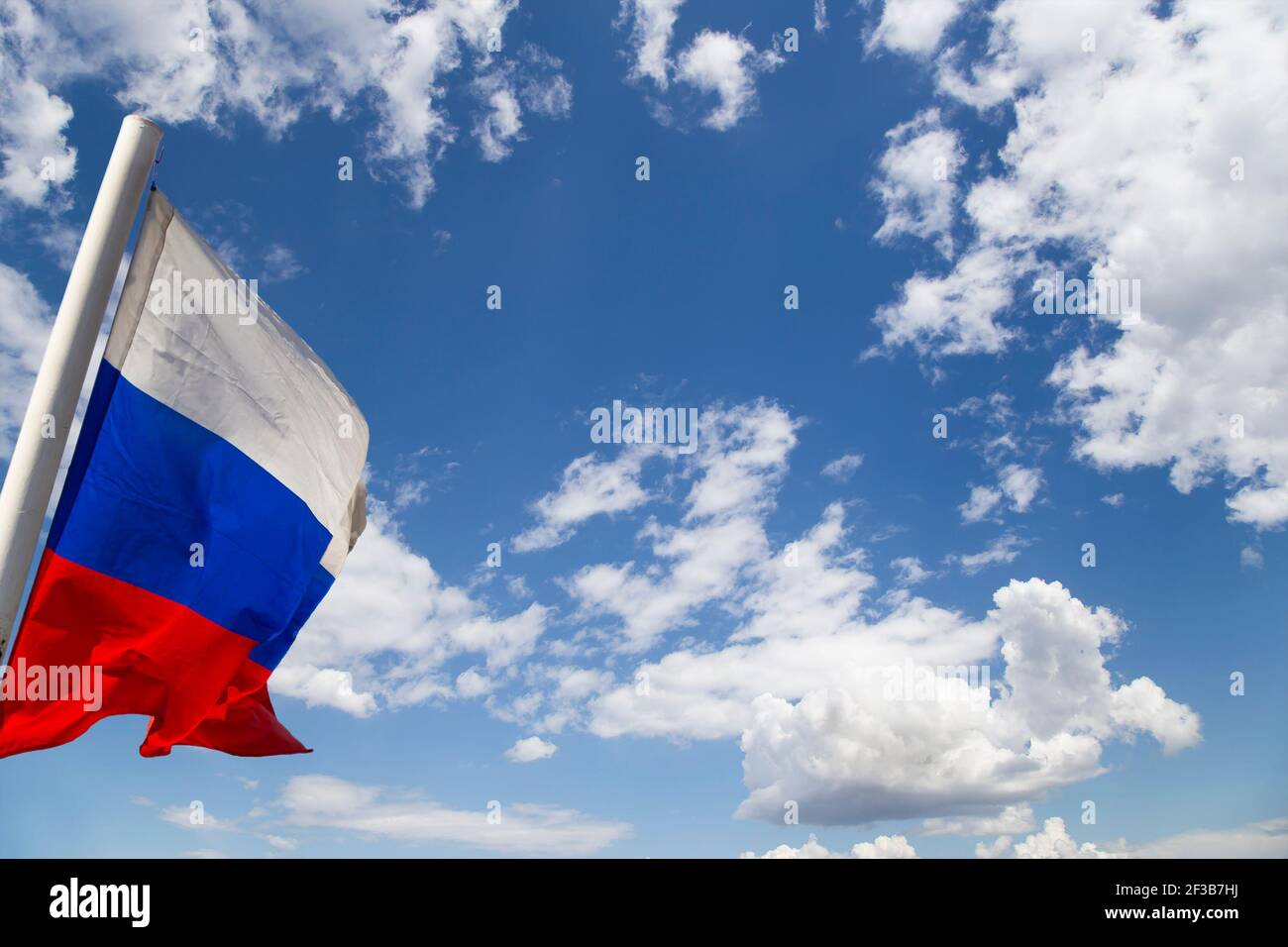 Russia flag waving in the wind against the sky. Three colors of Russian ...