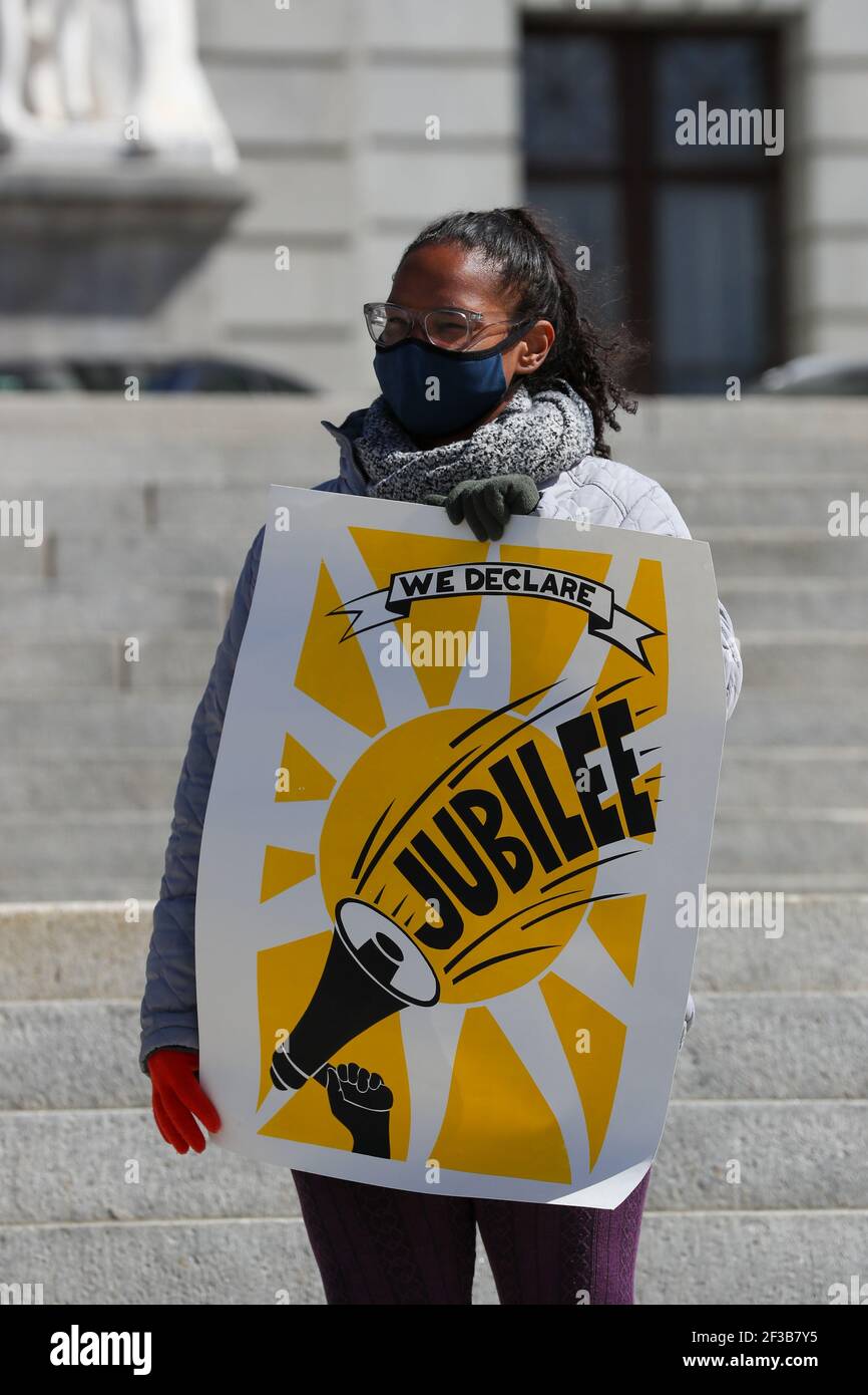 A woman holds a sign at the Pennsylvania State Capitol during a PA Poor ...